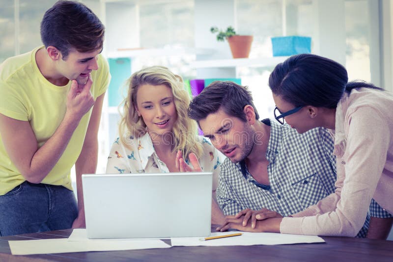 Creative Business Team Working on a Laptop Together Stock Photo - Image ...