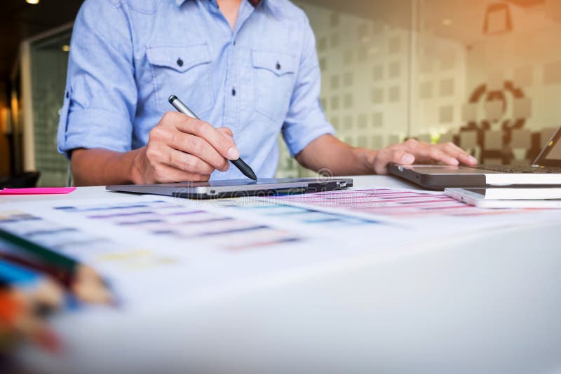 Creative Businessman or Designer Writing on Graphic Tablet while Stock ...