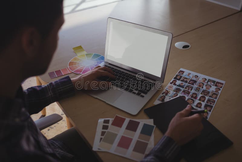 Creative Businessman Using Digitizer and Laptop on Desk in Office Stock ...
