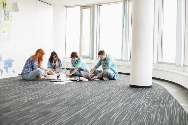Creative Businesspeople Working on Floor in Office Stock Photo - Image ...