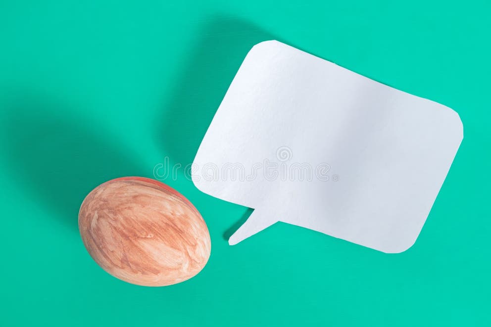 Creative Composition of Egg and Speech Bubble on a Green Background ...