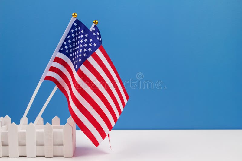 Creative Composition with Two American Flags on White Table with Blue ...