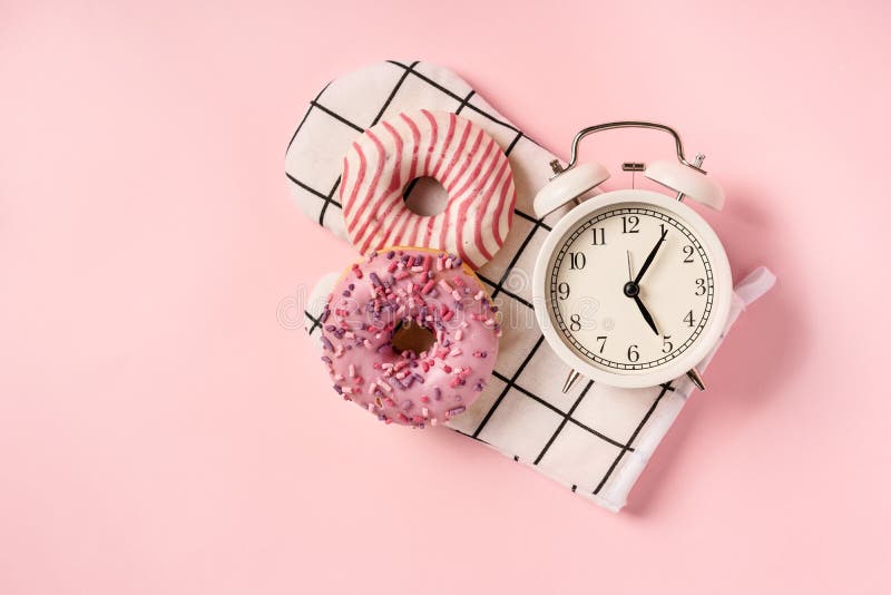 Creative Composition of Two Donuts and an Alarm Clock on a Pink ...
