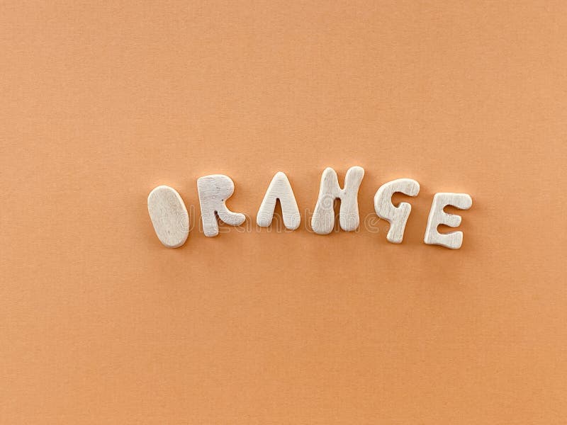 Orange Word Composed with Handmade Wooden Letters Over Orange Color ...