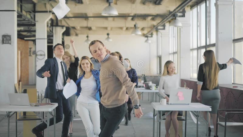 Creative Dancing in the Office. Employees Throw Up Papers and Join the ...