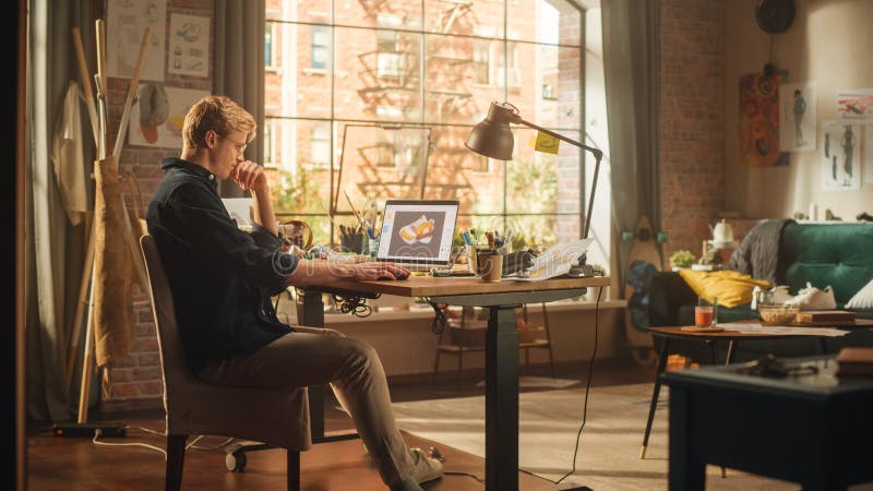 Creative Designer Works Behind the Desk on a Laptop Computer with 3D ...