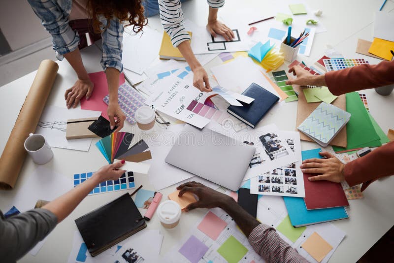 Creative Designers Discussing Production Over Table Stock Image - Image ...