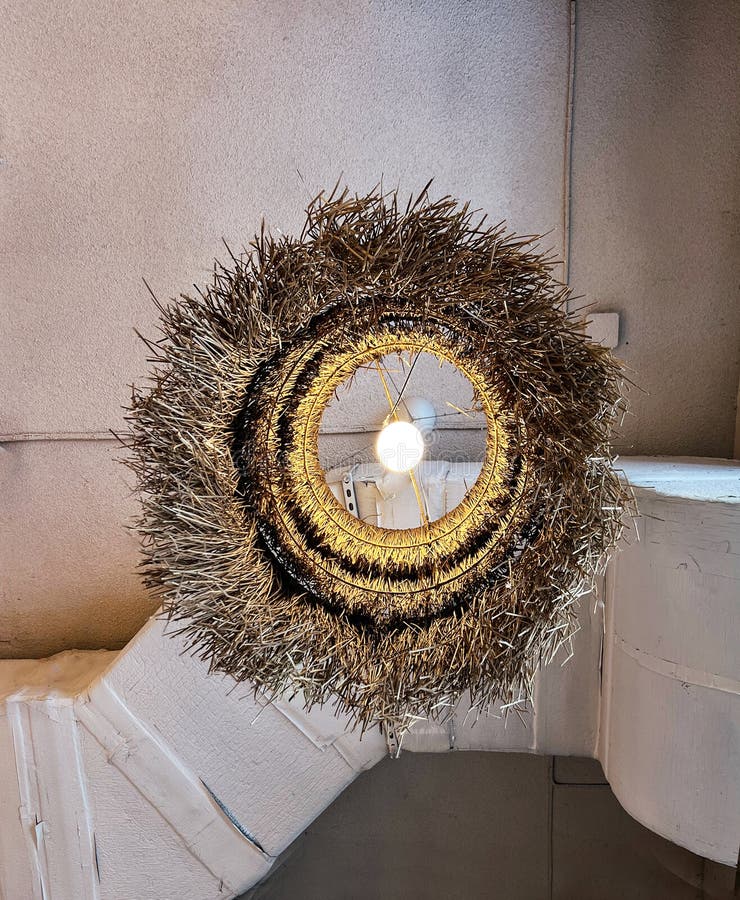 Creative Display of a Straw Lampshade Suspended from an Industrial ...