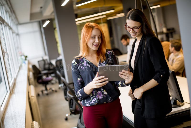 Creative Female Executives Using Digital Tablet in Office Stock Image ...