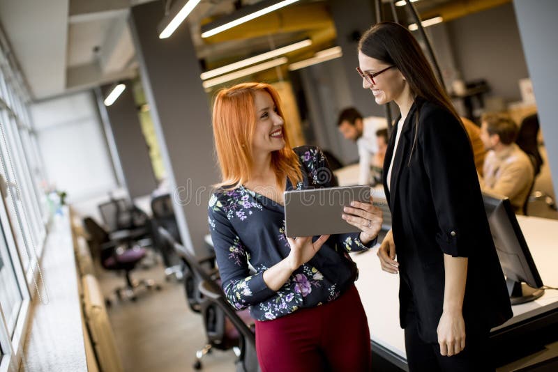 Creative Female Executives Using Digital Tablet in Office Stock Image ...