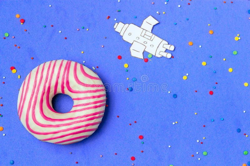 Creative Food Minimalism, Donut in Shape of Planet in Blue Sky with ...