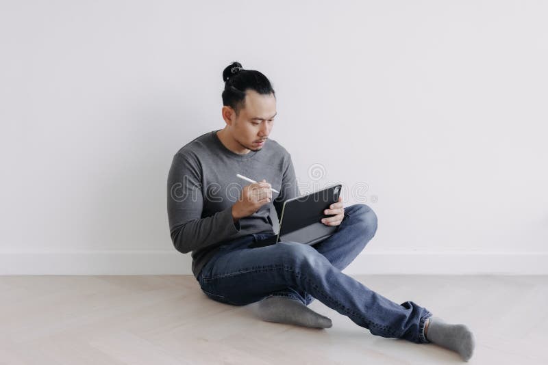 Creative Freelance Man Sitting on the Floor Working with Tablet. Stock ...