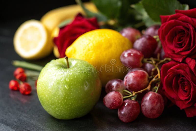 Creative Fruit Layout with Green Apple, Lemon, Grapes, and Roses Stock ...