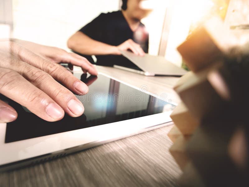 Creative Hand Working Digital Tablet and Wood Puzzle with Laptop Stock ...