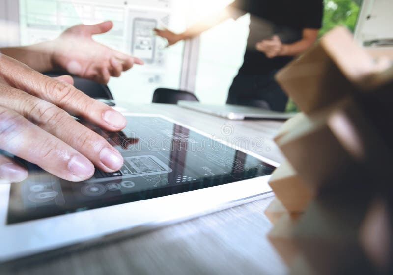 Creative Hand Working Digital Tablet and Wood Puzzle with Laptop Stock ...