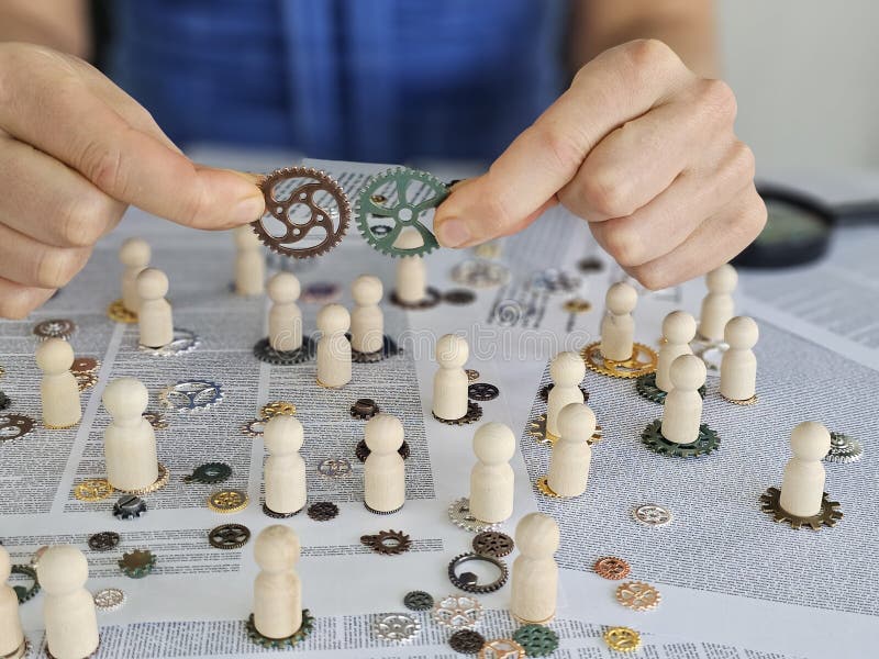 Creative Hands Arranging Miniature Figures and Gears on a Textured ...