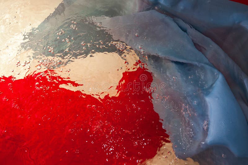 Creative Image of Wet Red and Blue Rumpled Material in Water with Waves ...