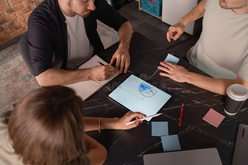 Team Collaboration Using a Tablet in a Modern Workspace Setting. Stock ...