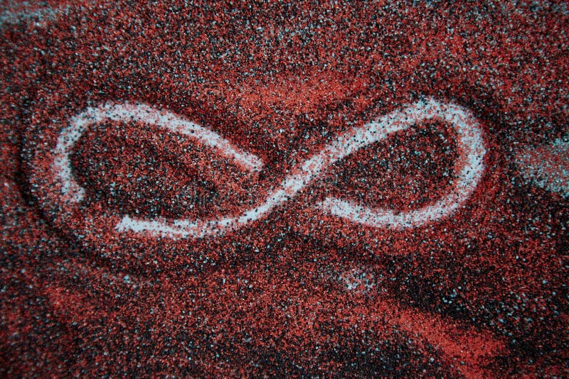 Creative Infinity Symbol on Bright Red and Black Sand Background. Stock ...