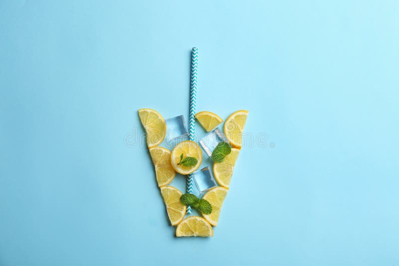 Creative Lemonade Layout with Lemon Slices, Mint and Ice on Blue ...