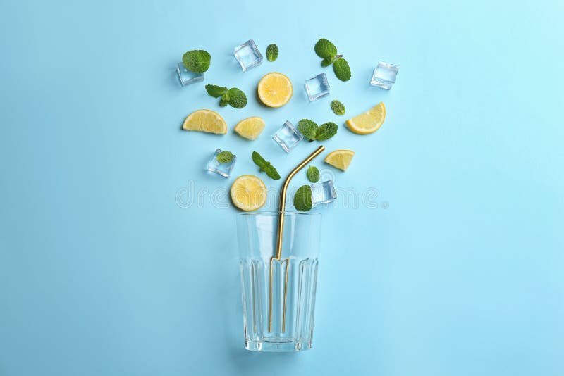 Creative Lemonade Layout with Lemon Slices, Mint and Ice on Light Blue ...