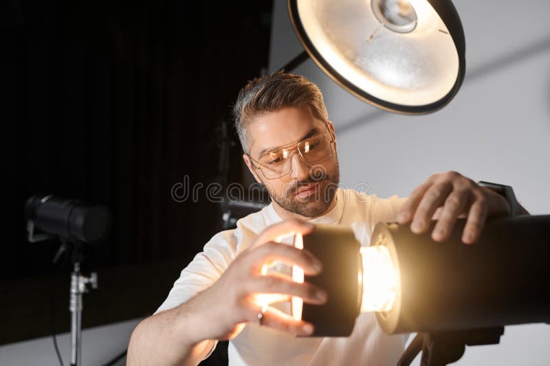 Creative Man Adjusting Lighting Equipment in Stock Image - Image of ...