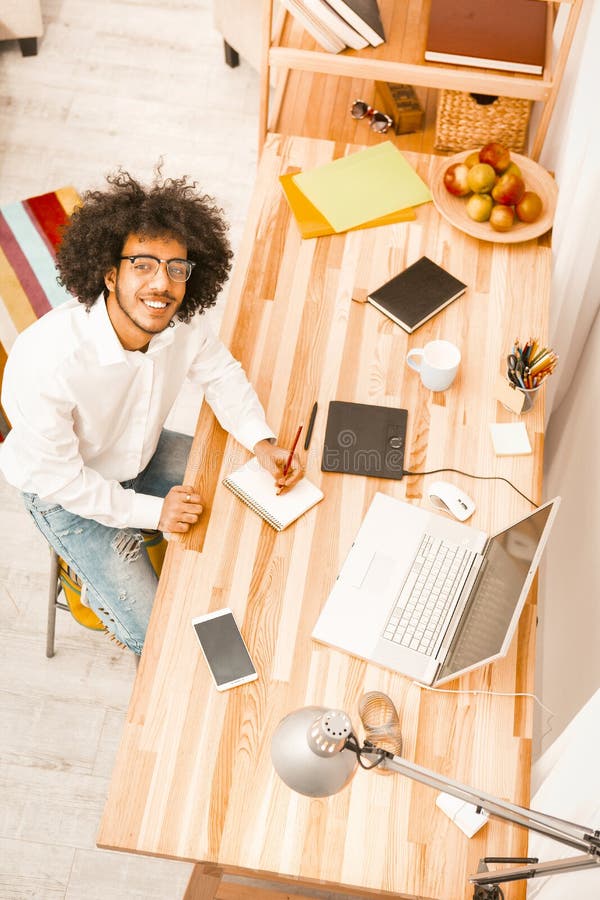 Creative Man Takes Notes in a Notebook Working or Studying while ...