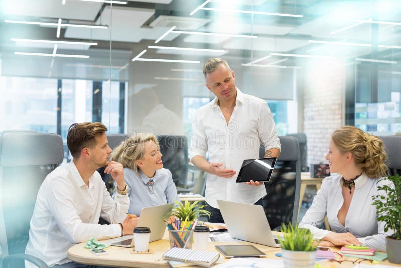 Man Presenting Something To His Co-workers on Tablet Stock Photo ...