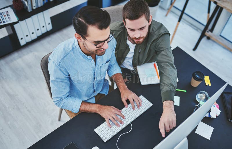 Creative, Men and Typing with Computer in Office for Internship ...