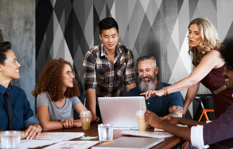 Creative Minds Dont Work, they Play. a Group of Designers Working Together on a Laptop in an ...