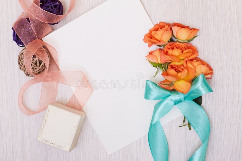 Creative Mock Up with a Card and Orang Rose. Empty Sheet of Paper ...
