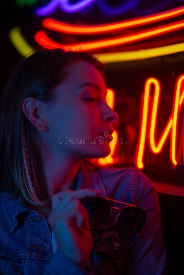 Creative Portrait Of A Girl In Neon Lighting With Glasses Stock Image