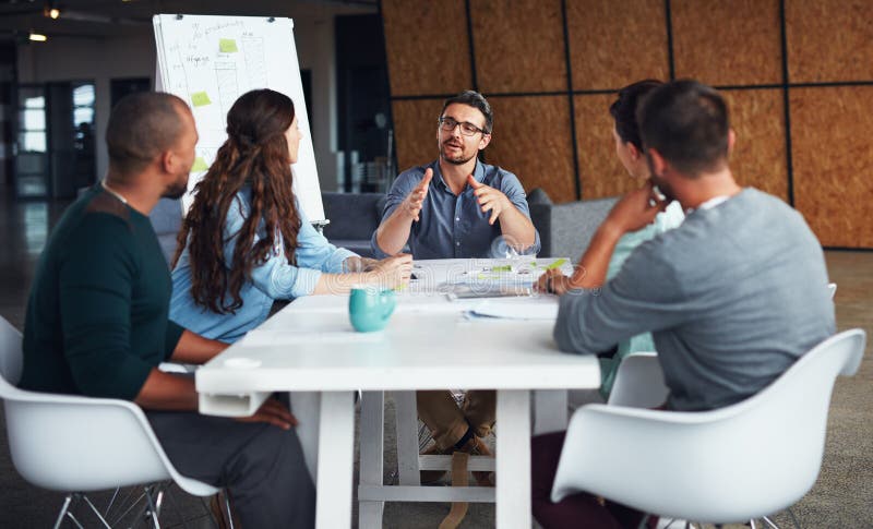 The Creative Process. a Mature Manager Talking To His Team while ...