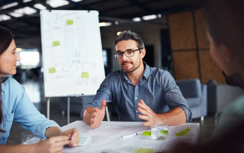 The Creative Process. a Mature Manager Talking To His Team while ...