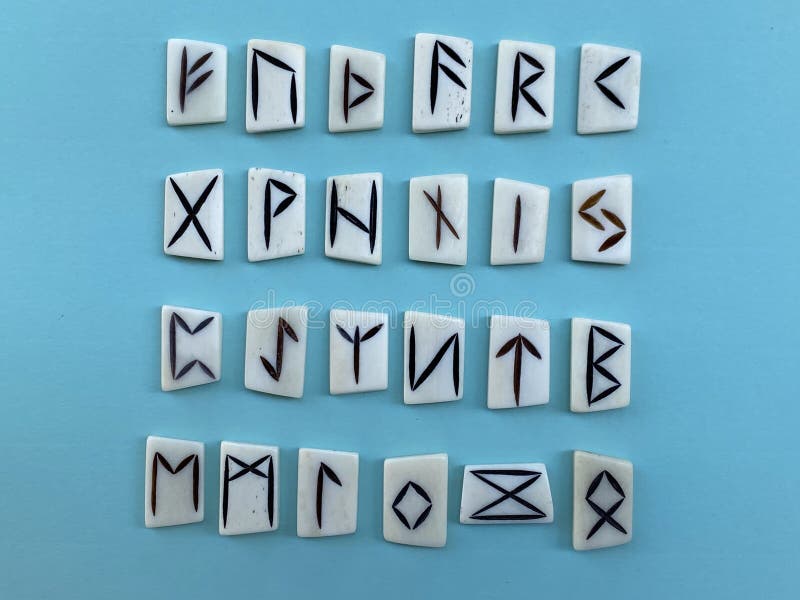 Runic Alphabet Composed with Bone Pieces Over Blue Background Stock ...