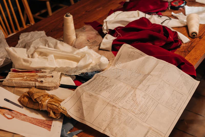 Creative Sewing Workspace with Fabric and Patterns Scattered on a ...