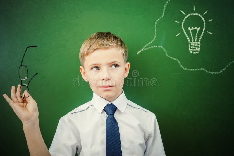 A Smart Boy, a Schoolboy, is Sitting at a Desk at Home, Studying Online ...