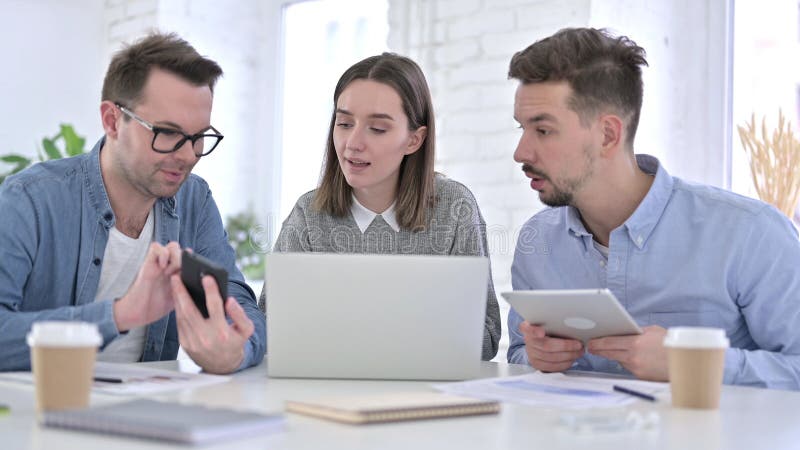 Creative Startup Team Working on Digital Devices in Modern Office Stock ...