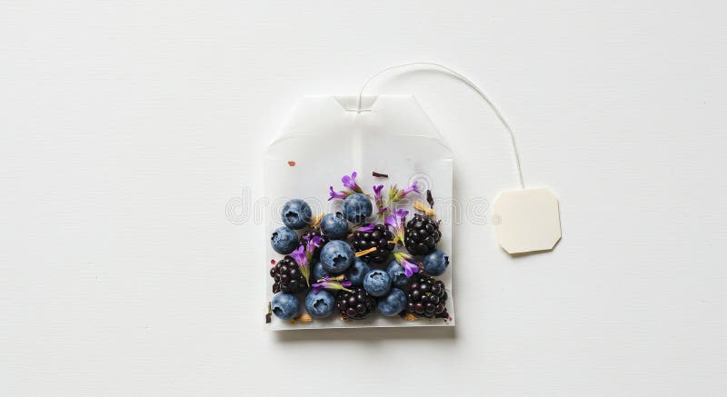 Creative Tea Bag Design with Fresh Berries and Floral Accents Stock ...