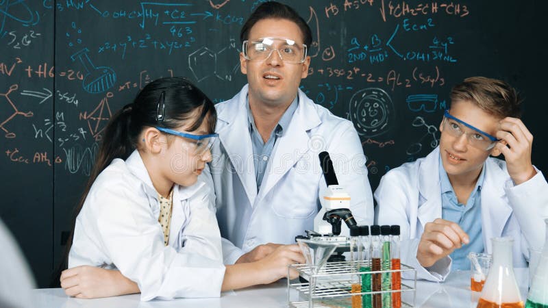 Creative Teacher Pointing at Blackboard while Talking To Smart Boy ...