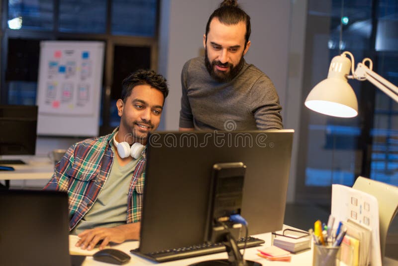 Creative Team with Computer Working Late at Office Stock Photo - Image ...