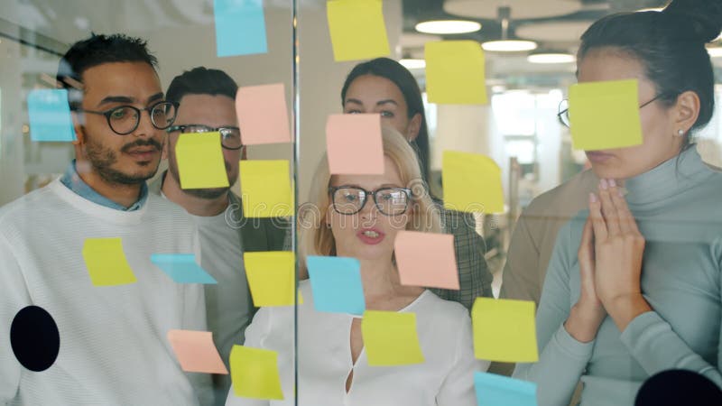 Creative Team of Coworkers Using Sticky Notes for Problem Solving ...