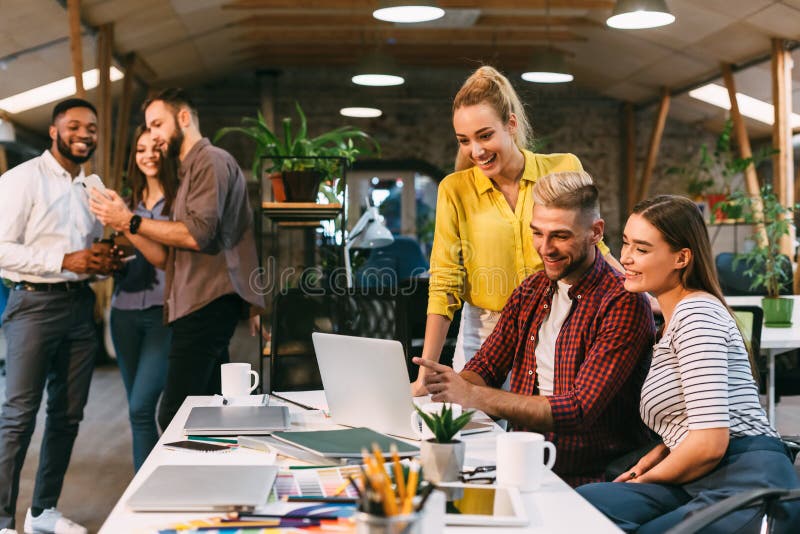 Creative Team Discussing New Marketing Strategy on Laptop Stock Photo ...