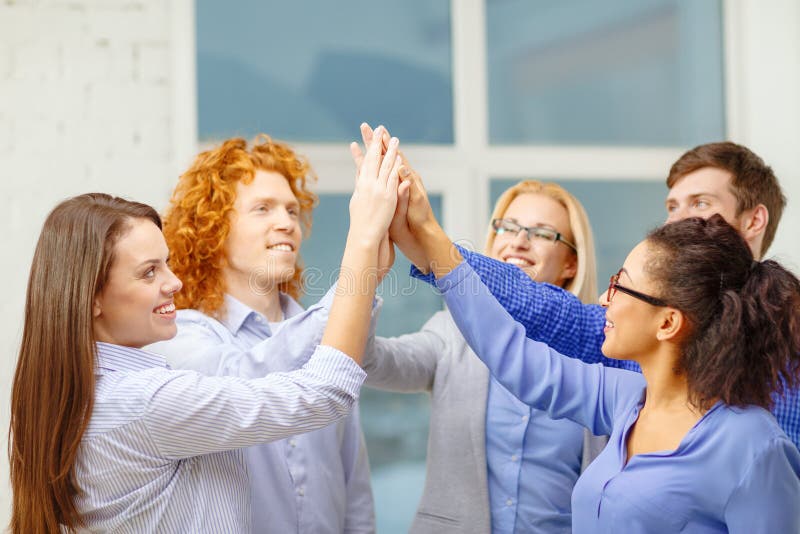 Creative Team Doing High Five Gesture in Office Stock Photo - Image of ...