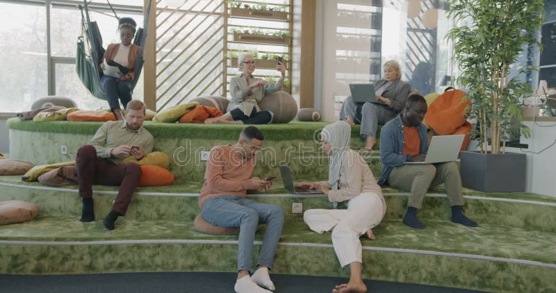 Creative Team of Employees Working with Laptops and Smartphones in ...