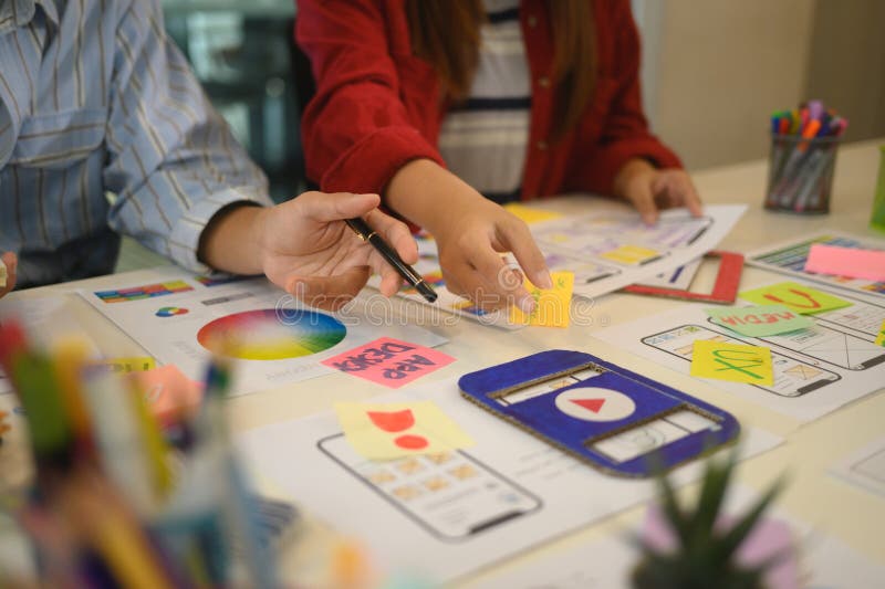 Creative Team Focused on Brainstorming App Design Ideas at a Workspace ...
