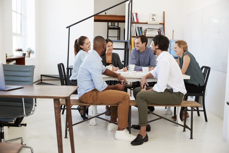 Creative Team Meeting Around a Table in an Office Stock Image - Image ...
