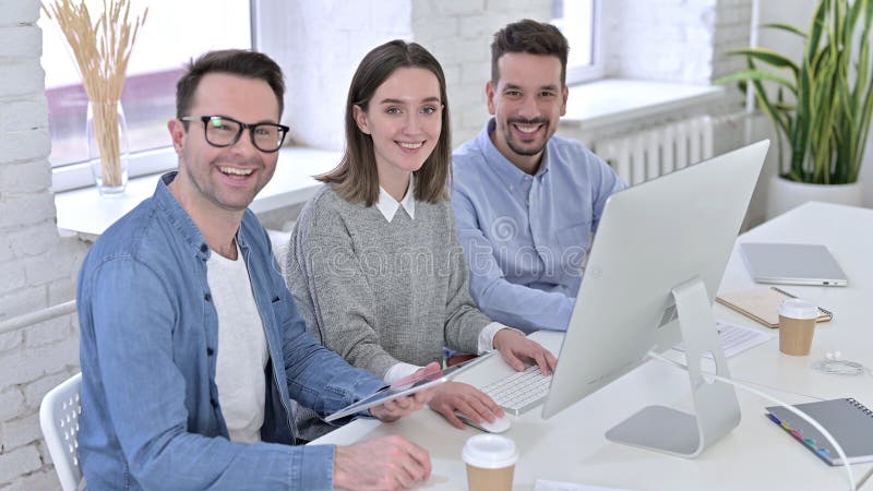 Creative Team Smiling while Looking at the Camera Stock Image - Image ...