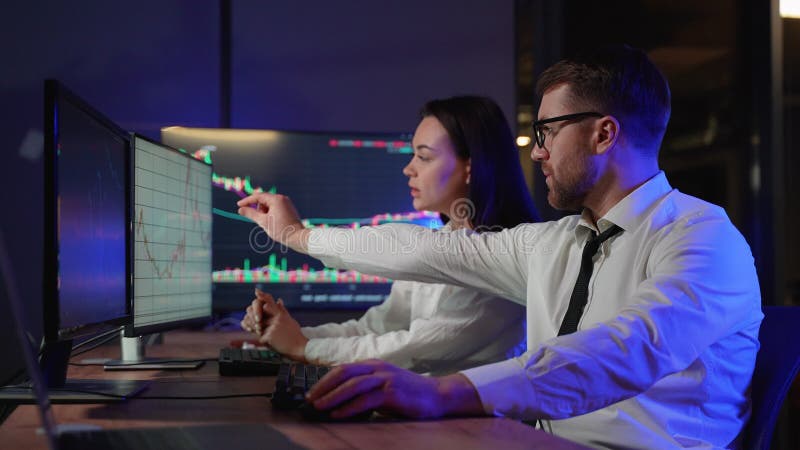 Creative Team of Traders are Having a Conversation in a Dark Office ...