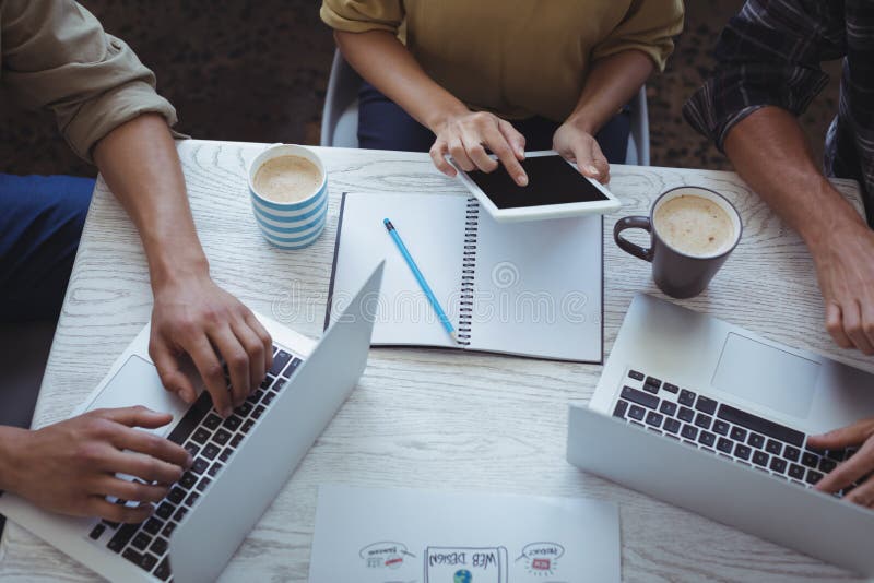 Creative Team Using Laptop and Digital Tablet while Planning in Office ...